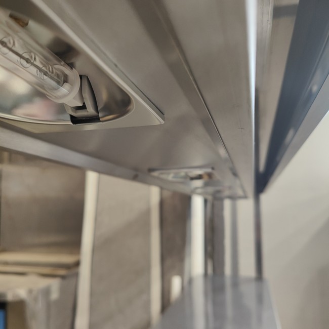 Pass though table with heated lamps